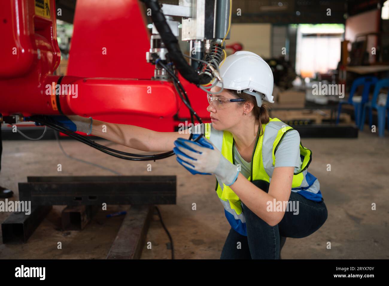 An engineers installing and testing a large robotic arm. before sending ...