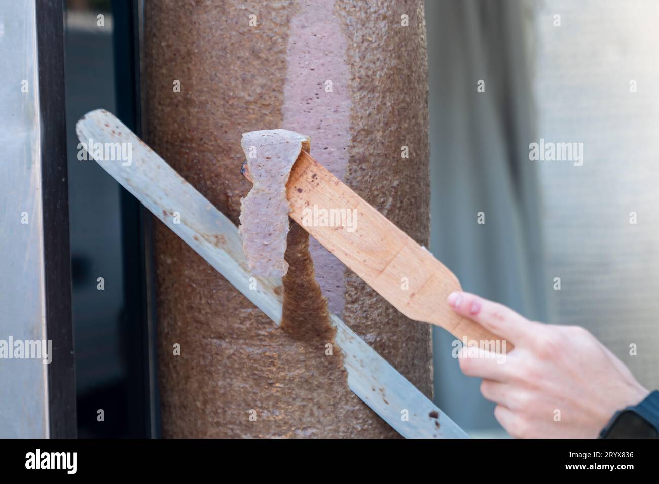 Chef cutting traditional Turkish food Shawarma meat Doner Kebab in the ...