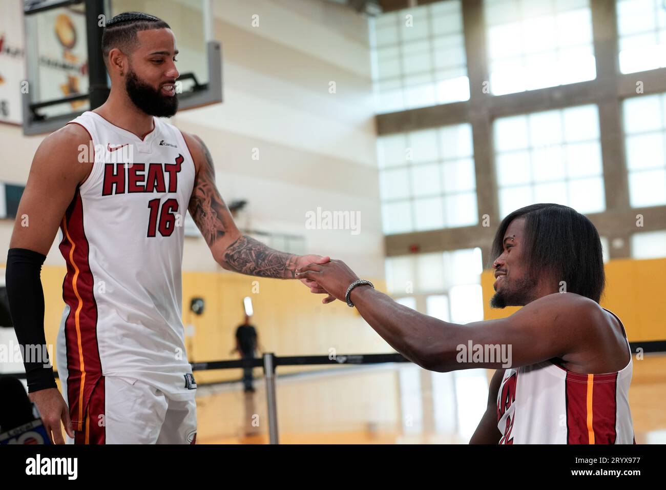 Miami Heat forward Caleb Martin (16) greets forward Jimmy Butler as he ...