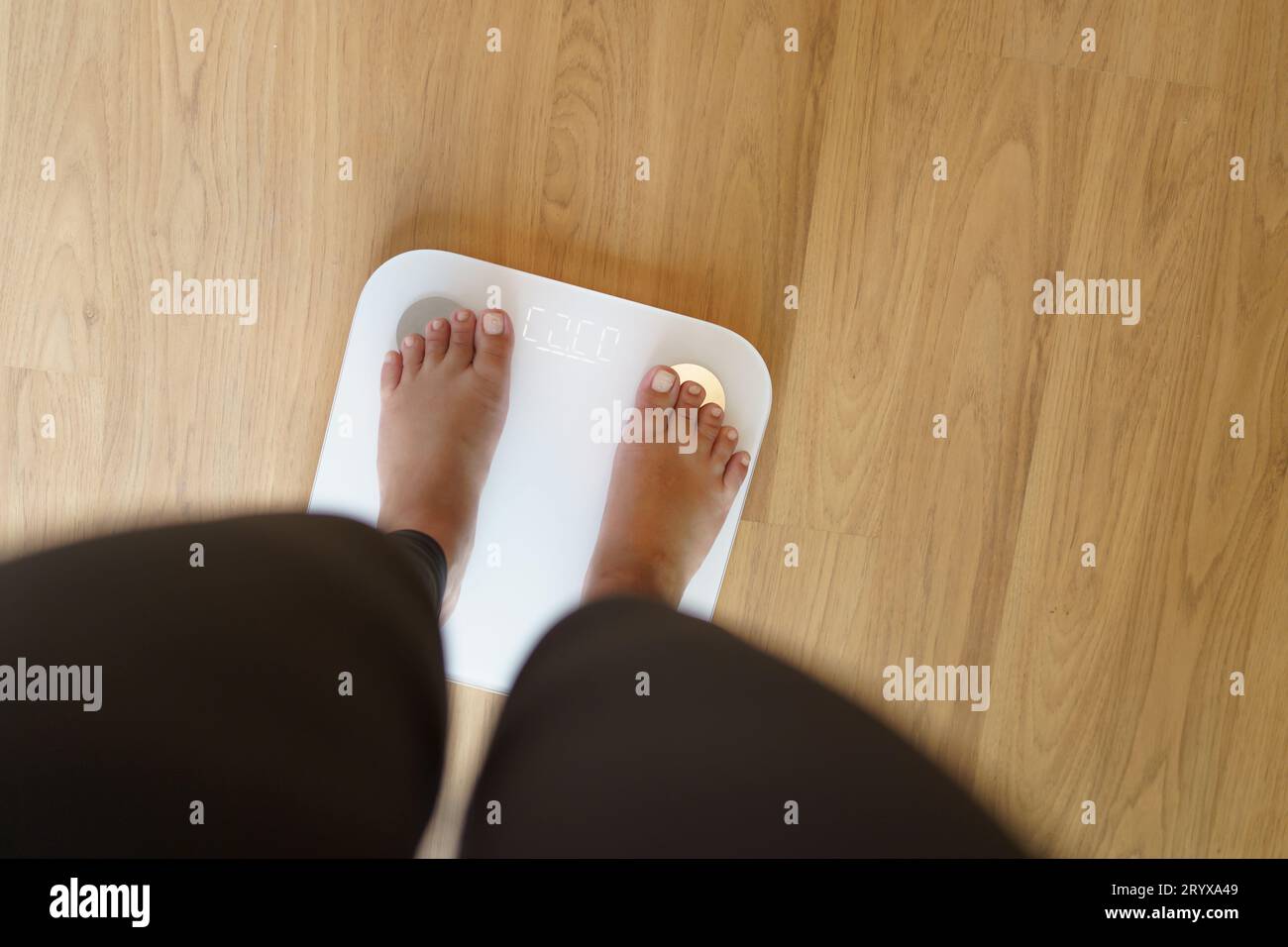 Lose weight. Fat diet and scale feet standing on electronic scales for ...