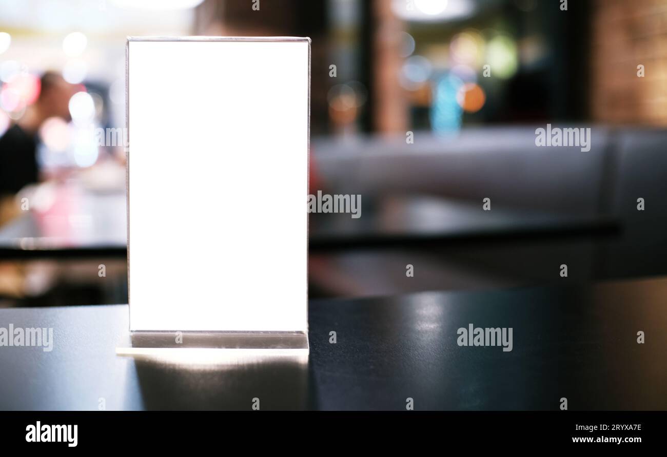 Menu frame standing on wood table in Bar restaurant cafe. space for ...