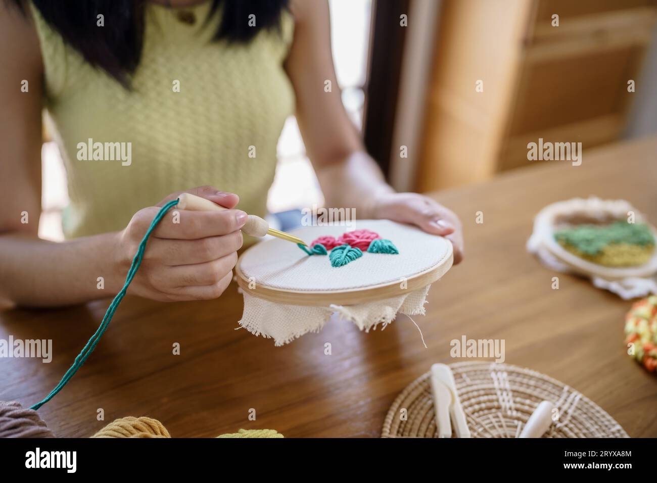 Punch needle. Asian Woman making handmade Hobby knitting in studio ...