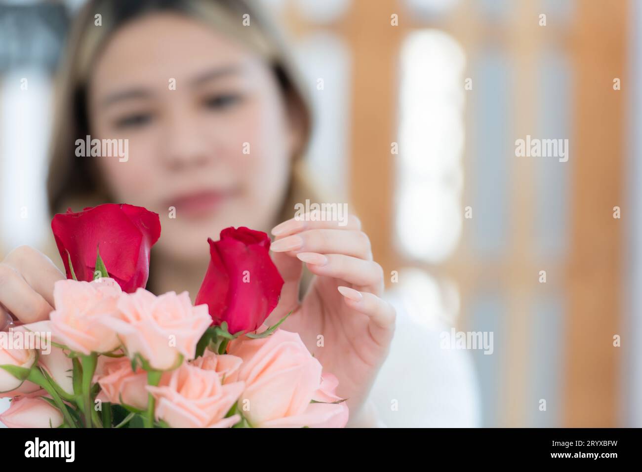 Beautiful young woman holding flower hi-res stock photography and ...