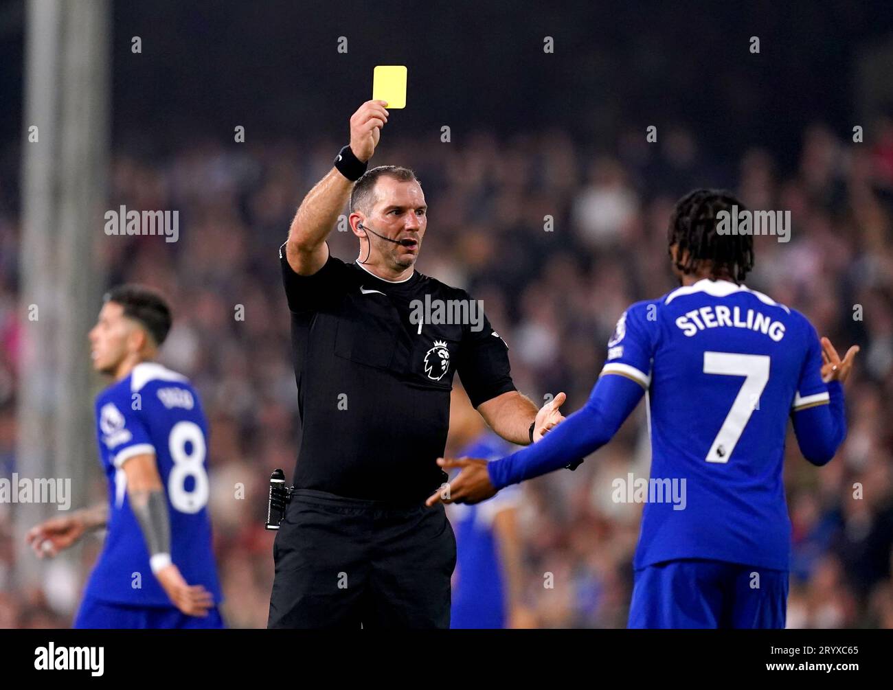Chelsea's Raheem Sterling is shown a yellow card by referee Tim ...