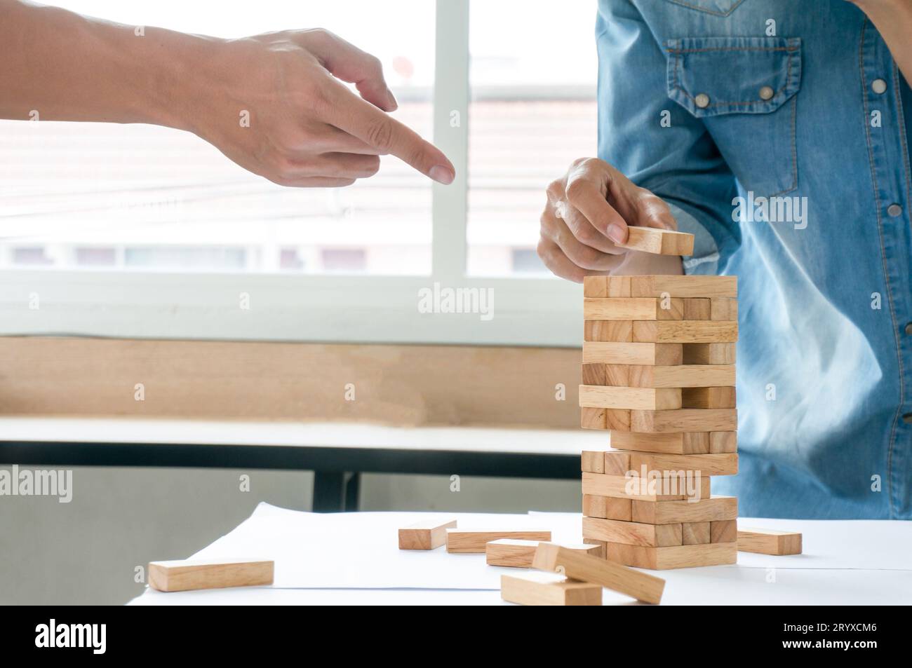 Group of Friends playing blocks wood gameÂ on the table folded puzzle ...