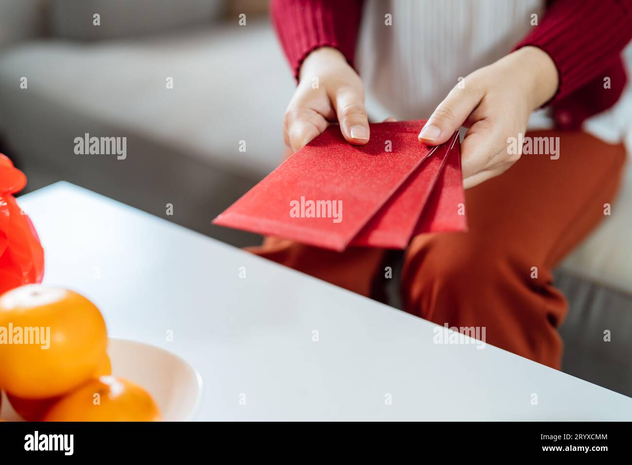 Asian Woman giving red envelope for Lunar New Year celebrations. Hand ...