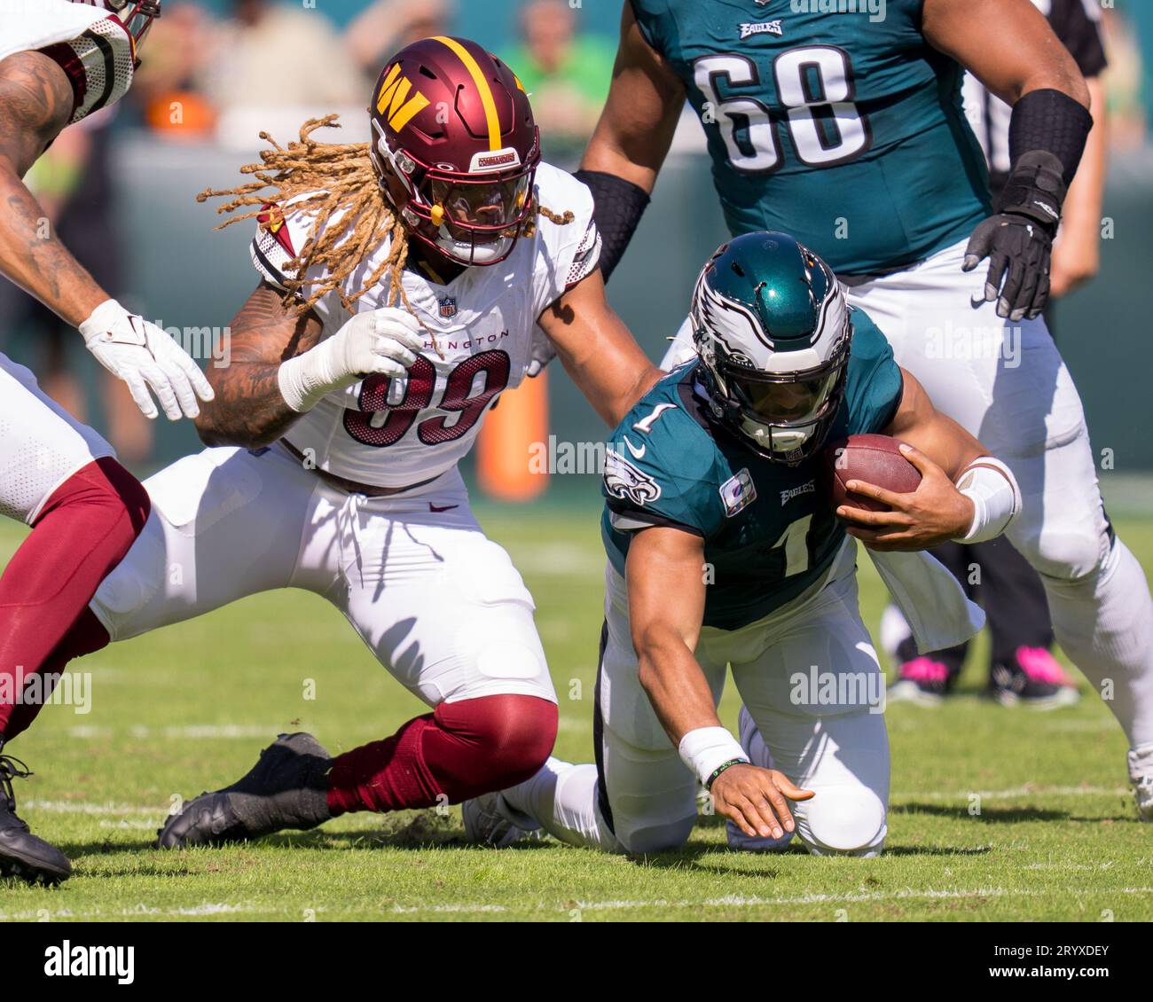 Chase Young #99 of the Washington Commanders sacks Jalen Hurts #1 of ...