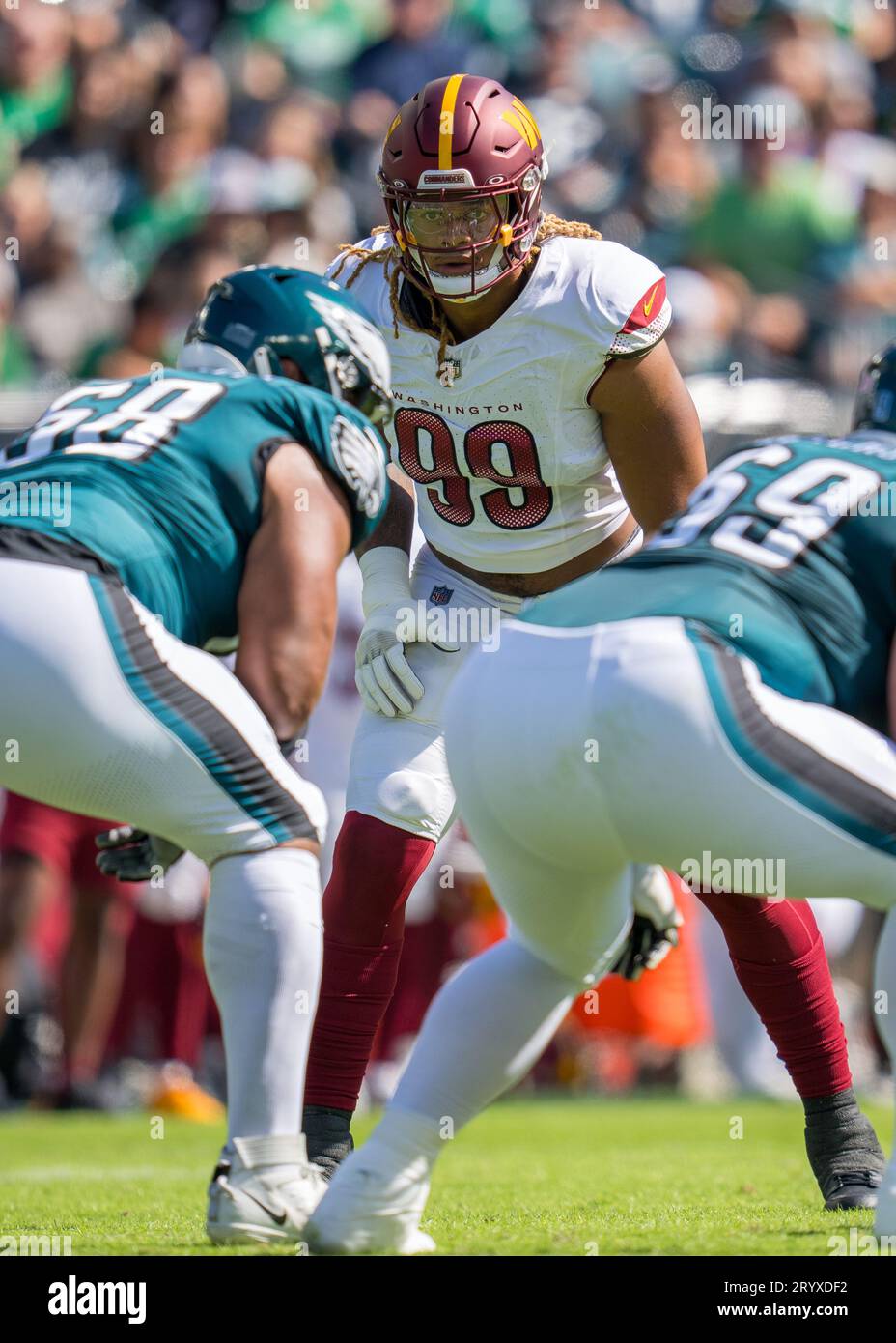 Chase Young #99 of the Washington Commanders peers into the backfield ...