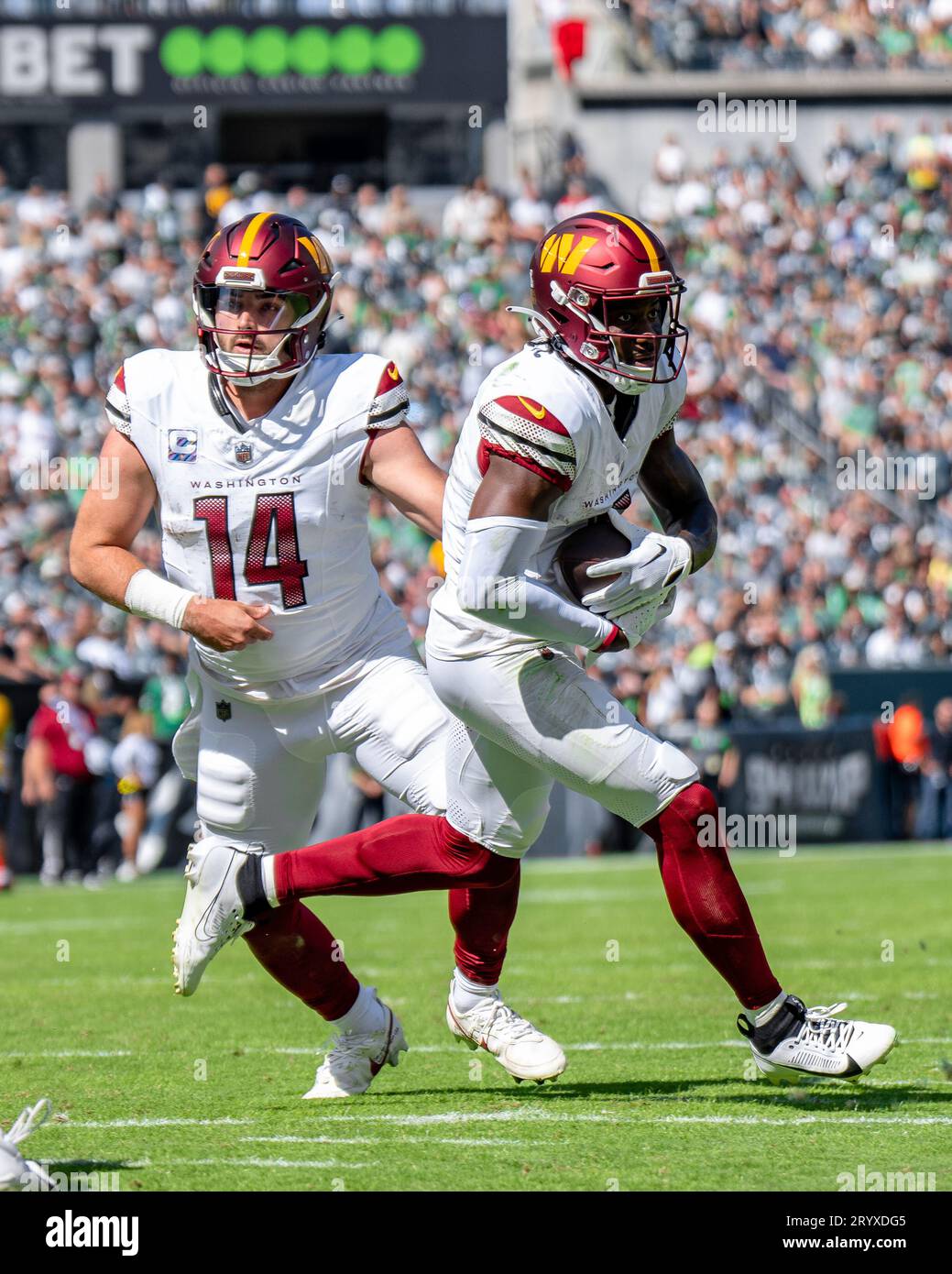 Sam Howell #14 of the Washington Commanders hands the ball off to ...