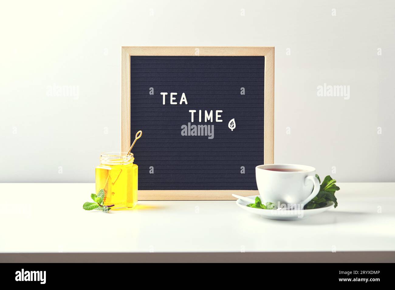 Tea time. Black letter board with text on table with glass cup of tea ...