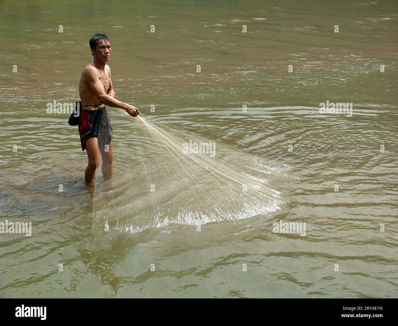 Ba Be lake in north Vietnam. Fisherman throwing a fish net Stock Photo ...
