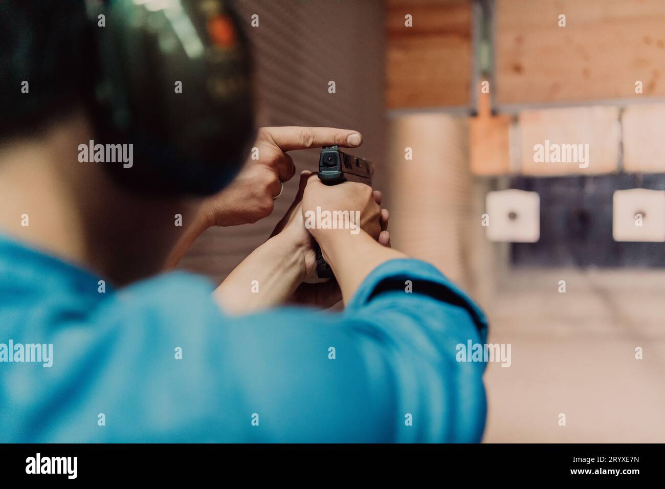 The trainer explaining to the man how to use the gun. Training in the ...