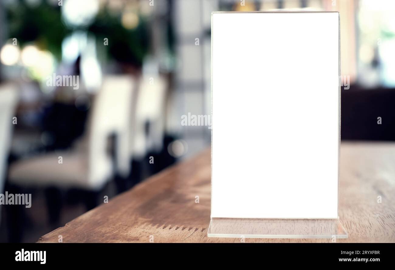 Menu frame standing on wood table in Bar restaurant cafe. space for ...