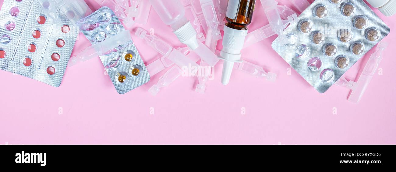 Medications and medical ampoules on pink background. Tablets, drugs and ...