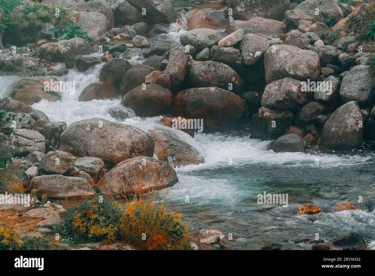 Natural spring water flowing from the mountains. Stream and stones ...
