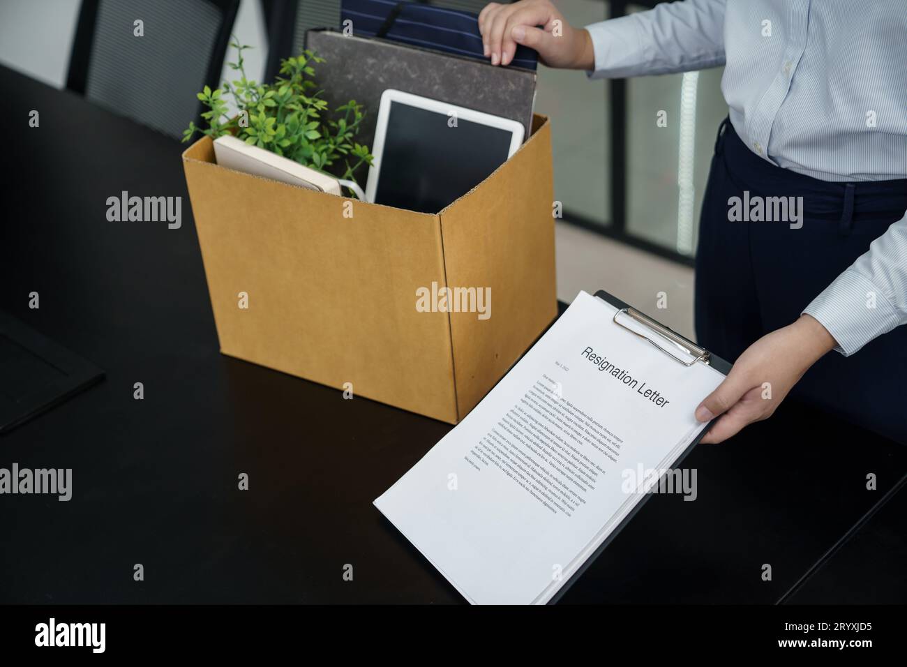Business woman sending resignation letter to boss and Holding Stuff ...