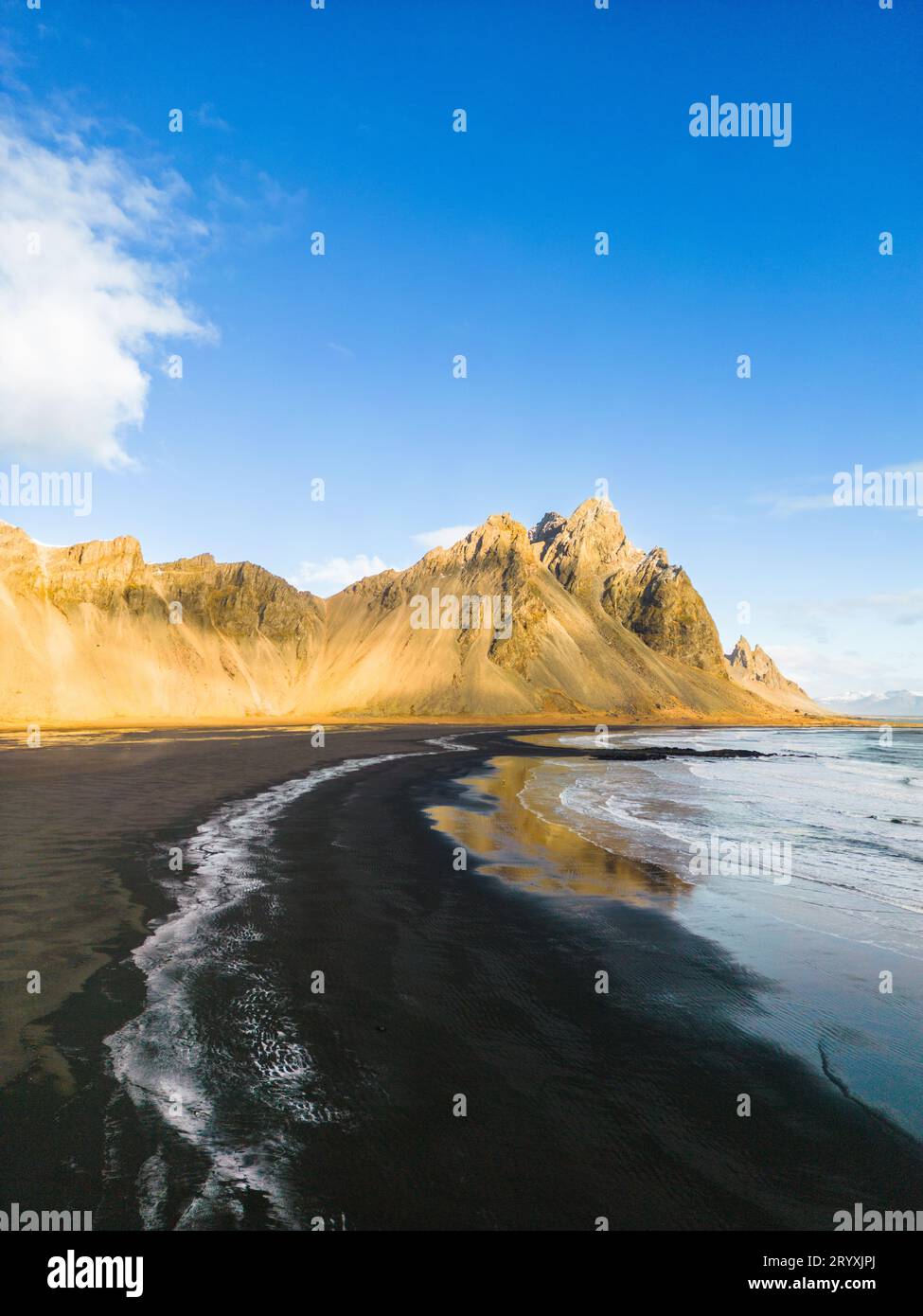 Northern scenery along ocean shore with massive Vestrahorn mountain ...