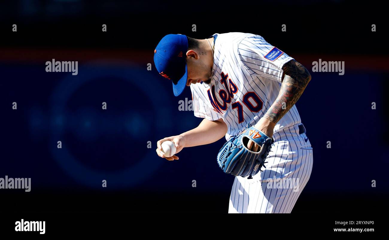 New York Mets starting pitcher Jose Butto pauses before pitching ...