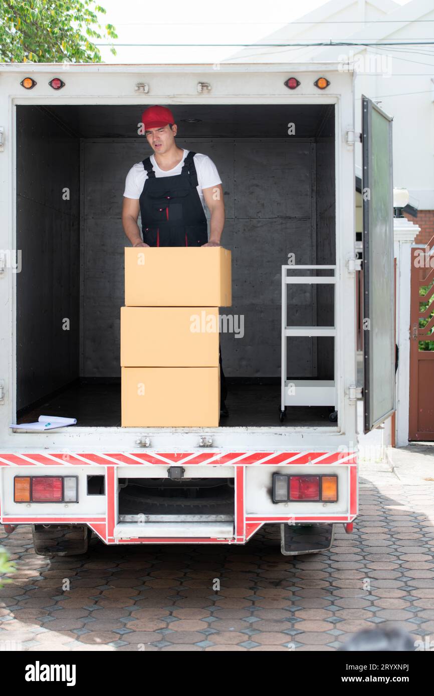 Delivery man with boxes in the truck, delivery and logistics concept ...