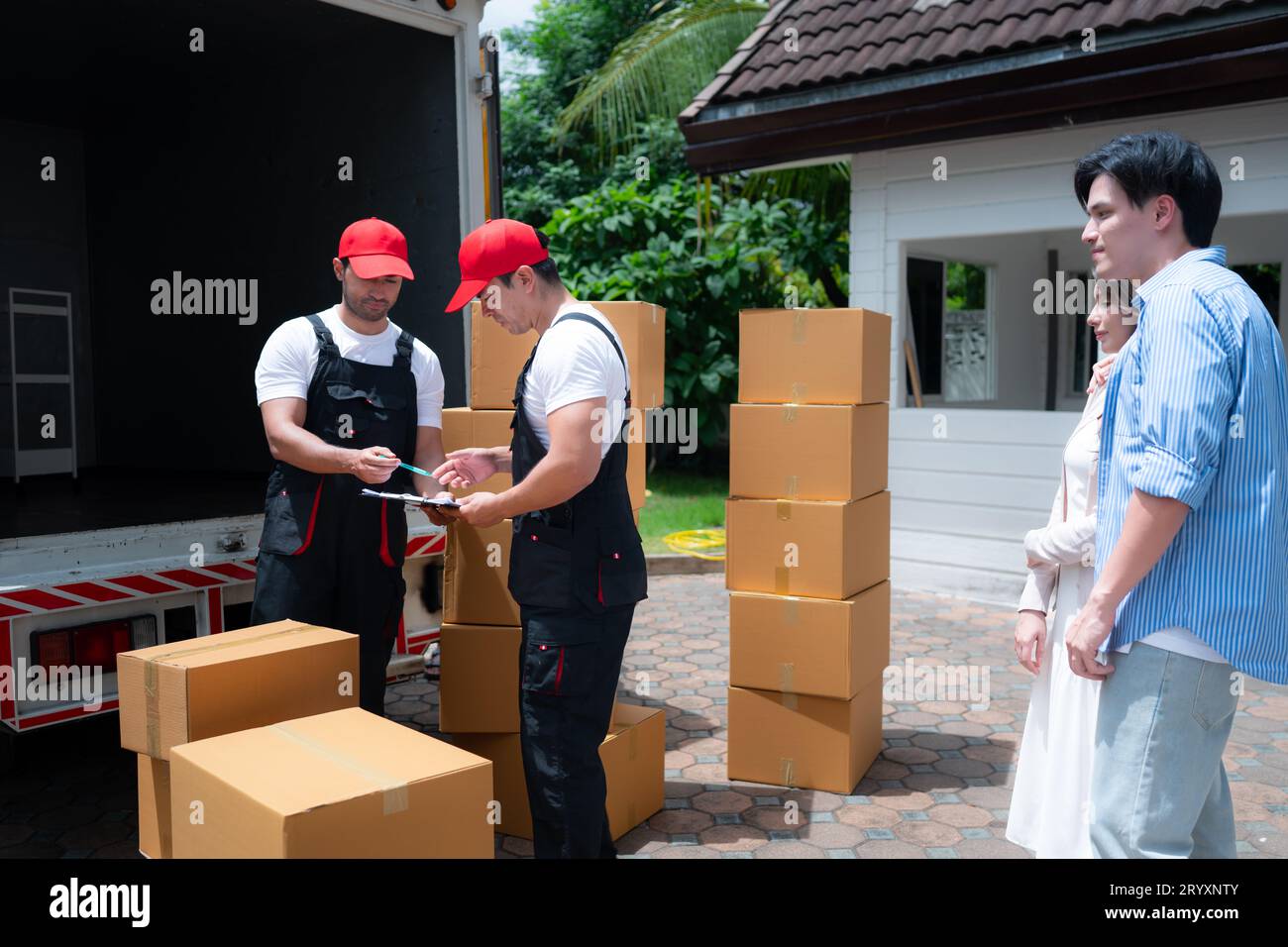 Delivery man delivering parcel to customer at home. Delivery service ...