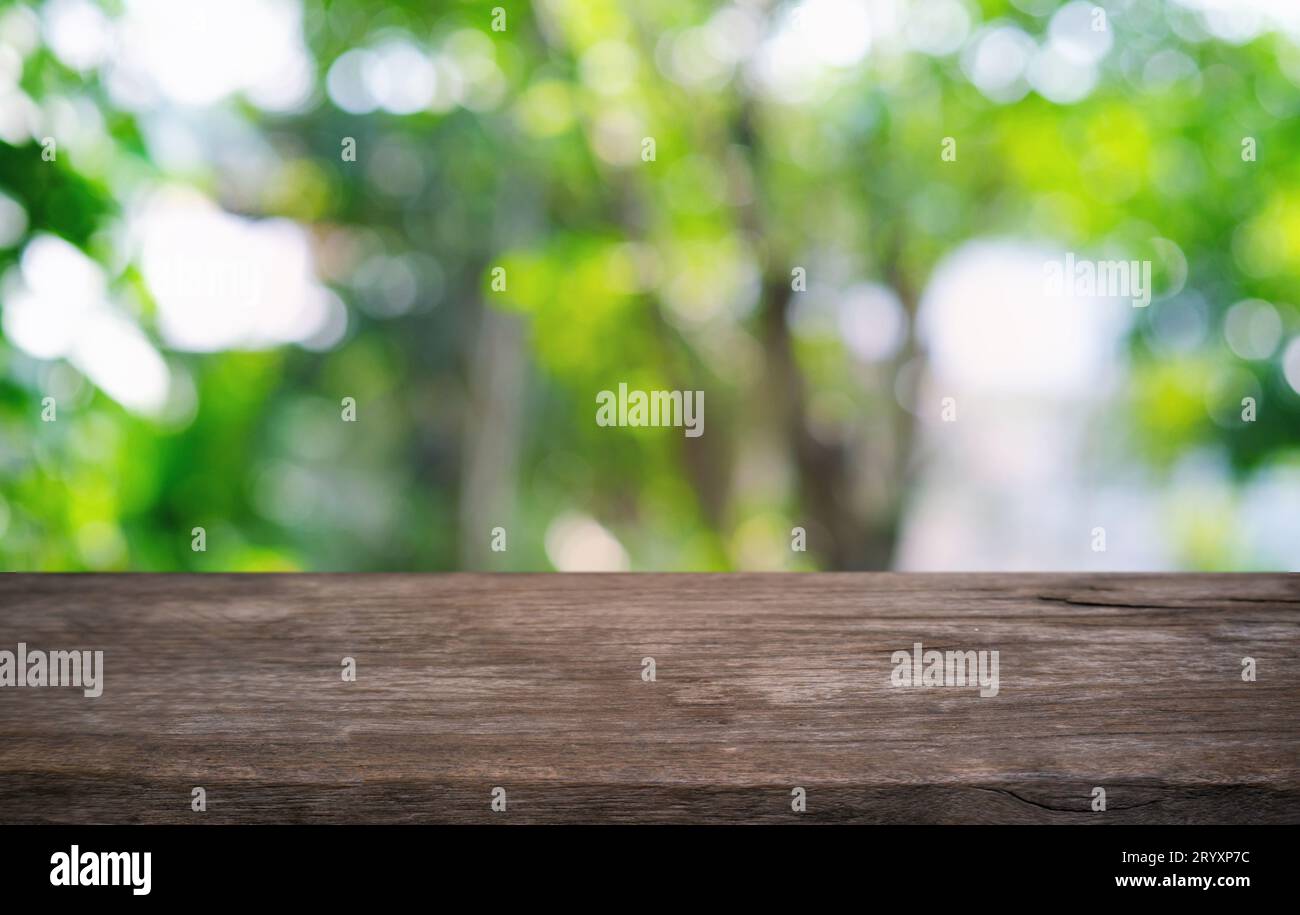 Empty dark wooden table in front of abstract blurred bokeh background ...