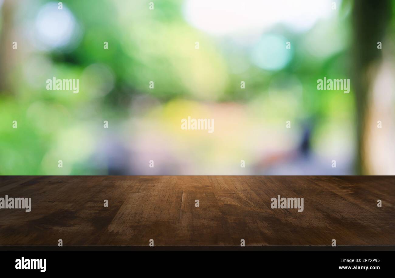 Empty dark wooden table in front of abstract blurred bokeh background ...