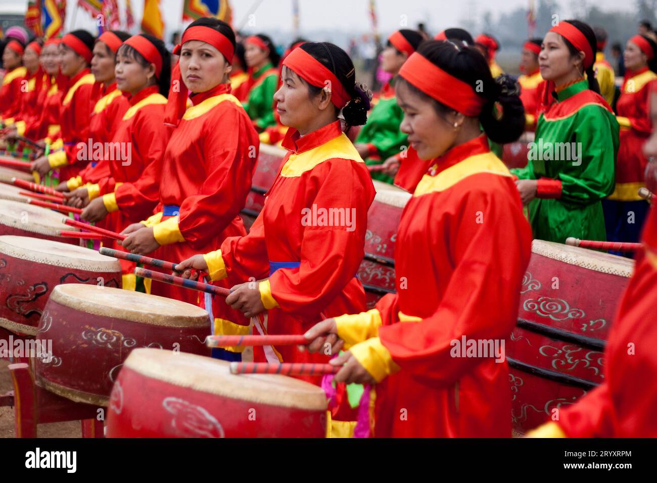 A group of vietnamese women play drums at buffalo painting festival ...