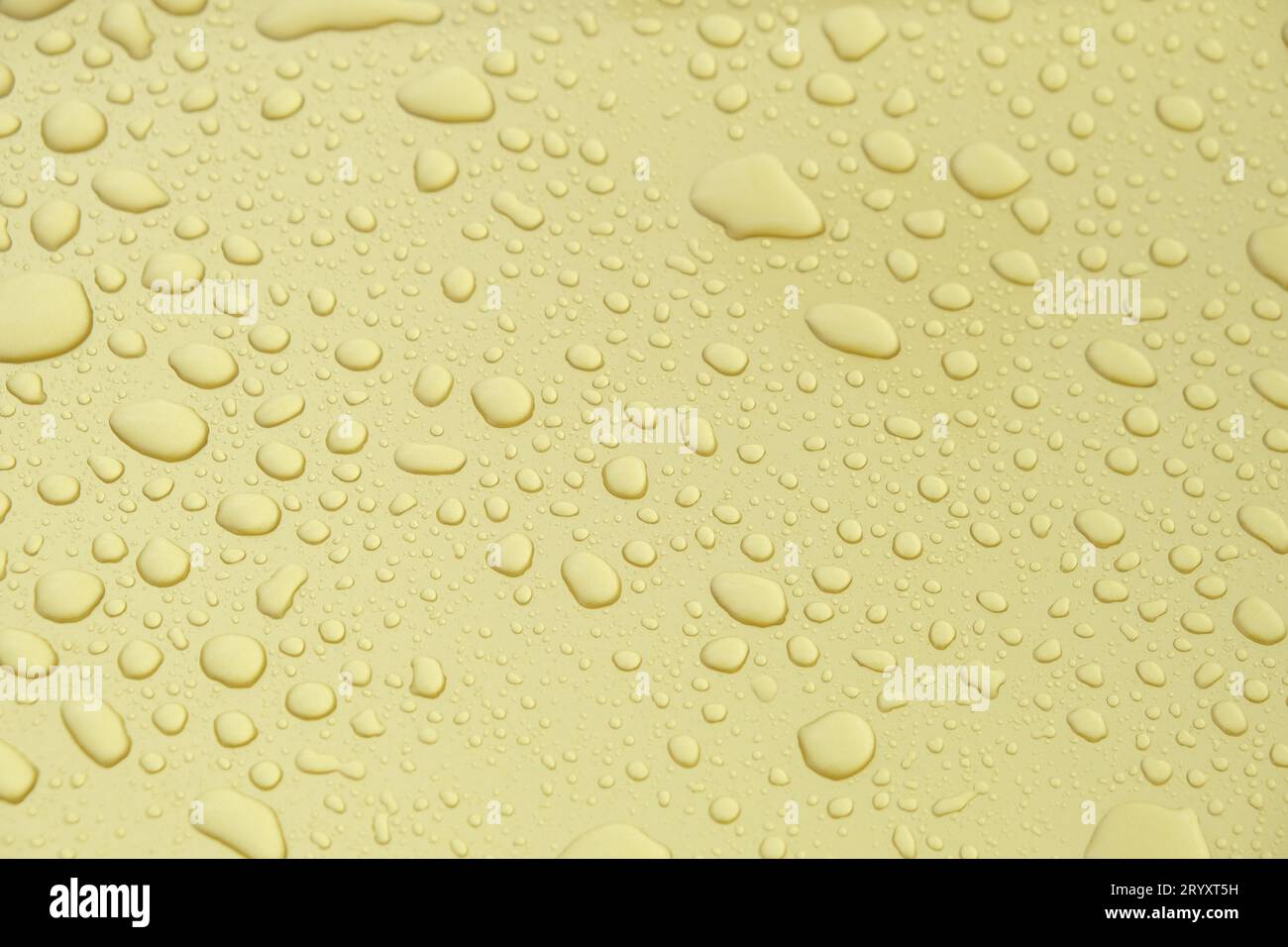 Close up water drop abstract background wallpaper on yellow color wet ...