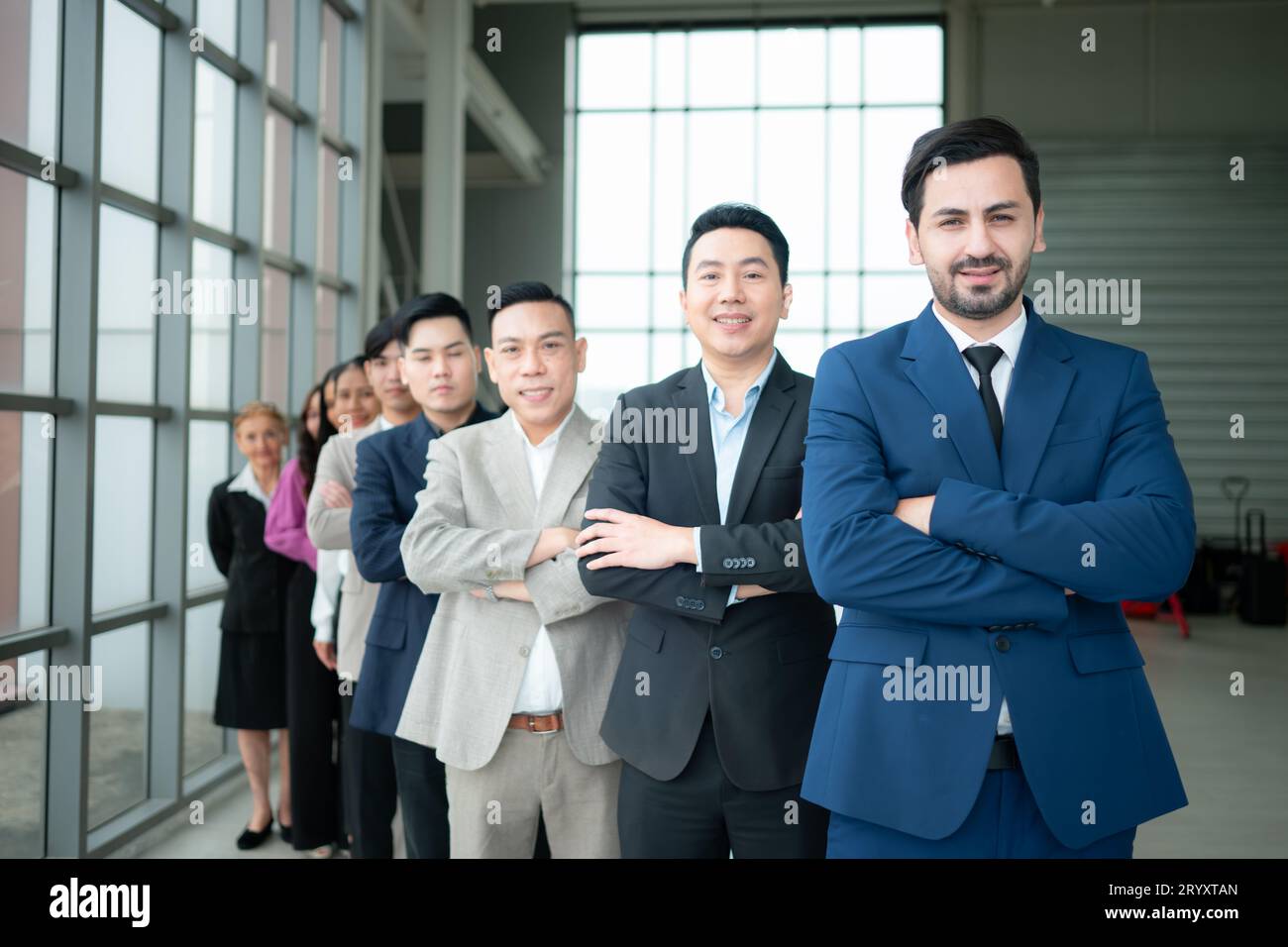 Group of business people standing in line in conference room used for ...