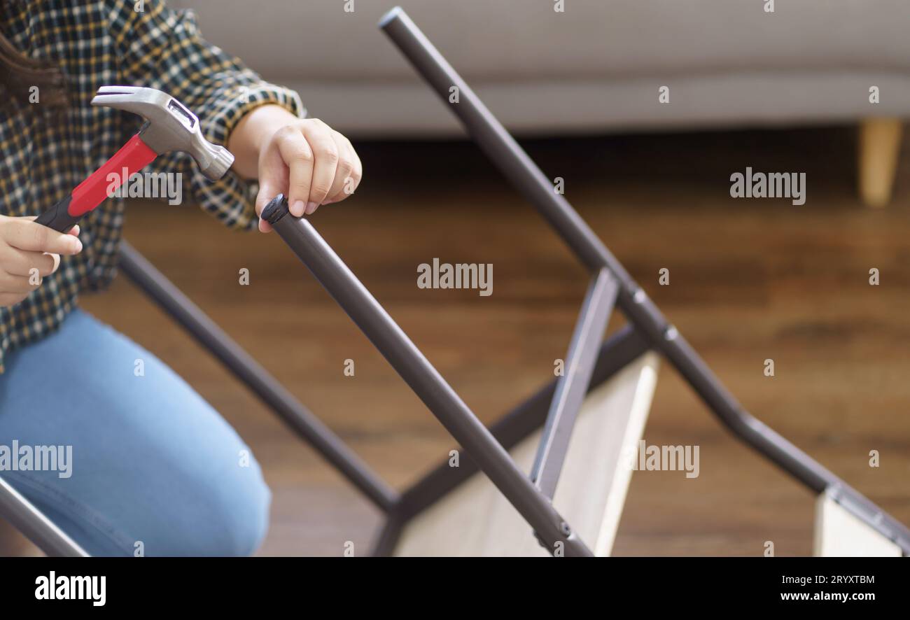 Asian Woman self repairs furniture renovation using equipment to diy ...