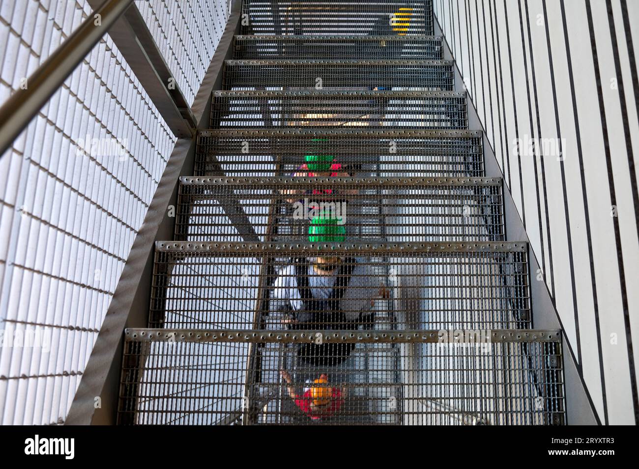 People on a grating staircase of the former industrial plant Phoenix ...