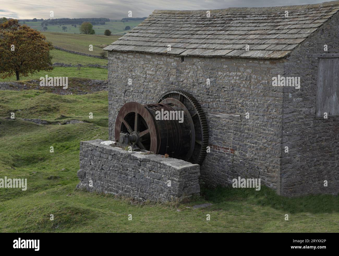Winding gear of a disused lead mine on the side of an old stone ...