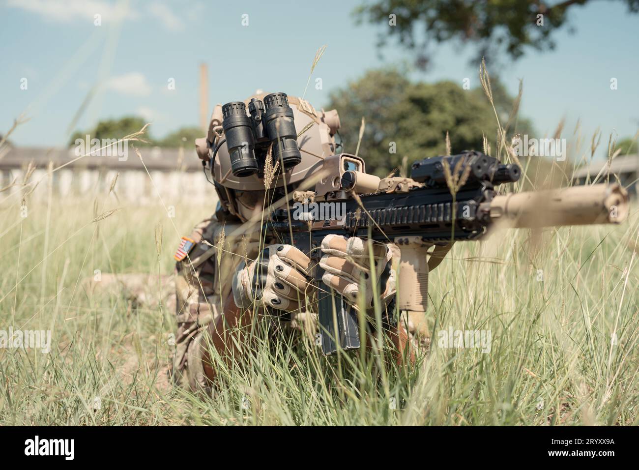 Special forces soldier in camouflage with a pair of weapons that are ...