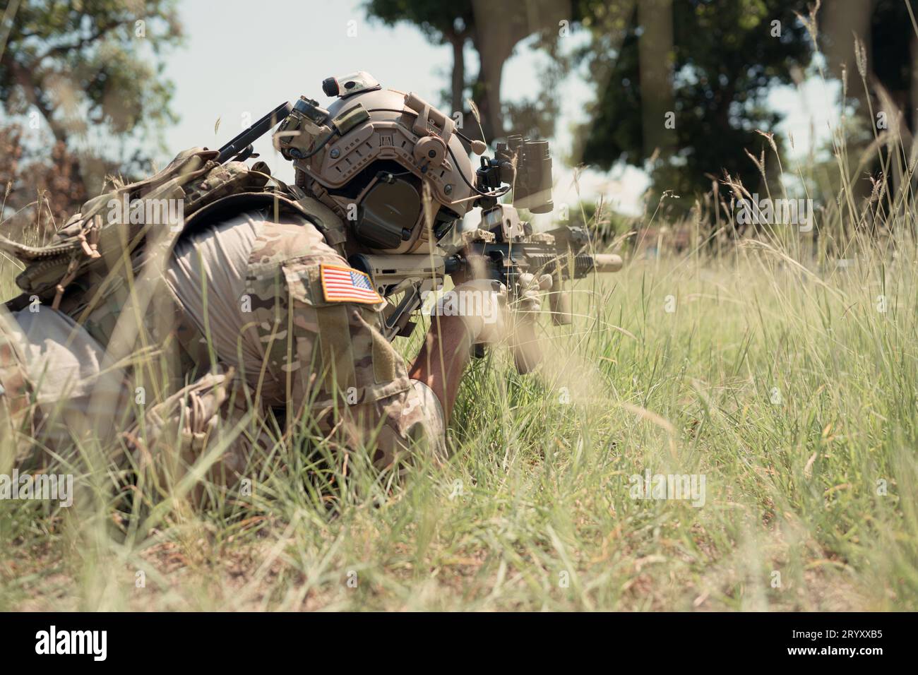 Special forces soldier in camouflage with a pair of weapons that are ...
