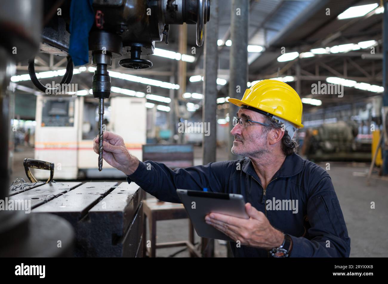 An elderly technician uses a computer to test the operation control of ...