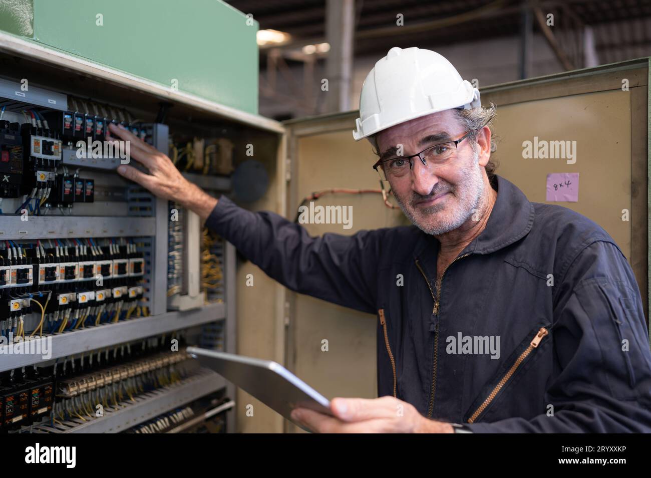 Senior engineer inspects the electrical system and repairs the ...