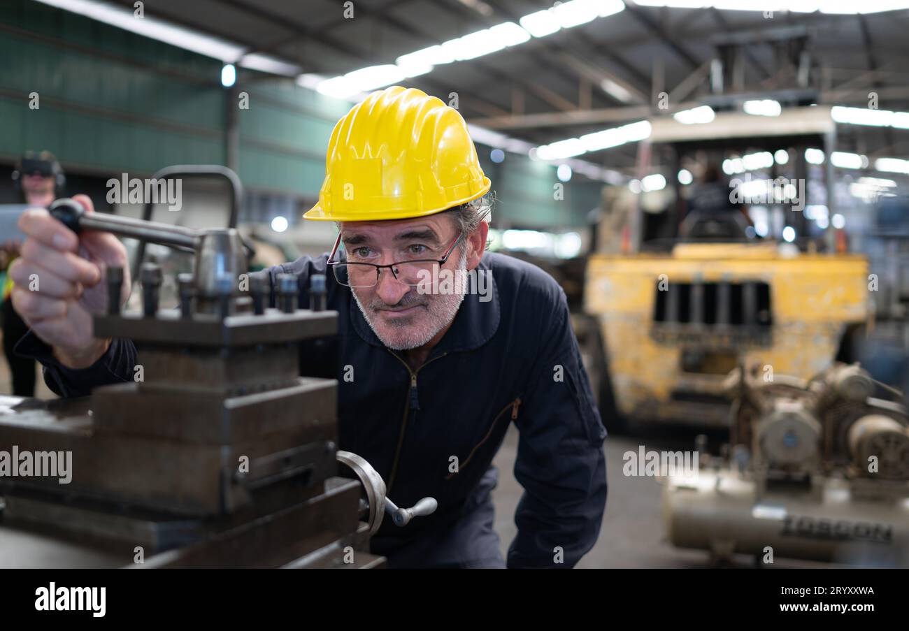 An elderly technician uses a computer to test the operation control of ...