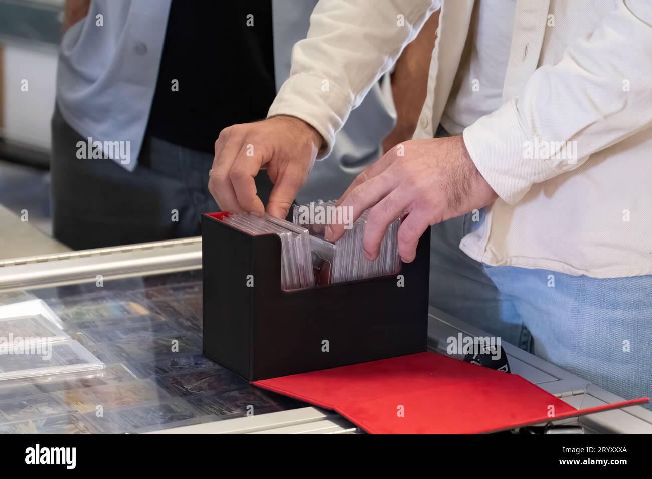 Sports card collector looking through all the vendor's baseball cards ...