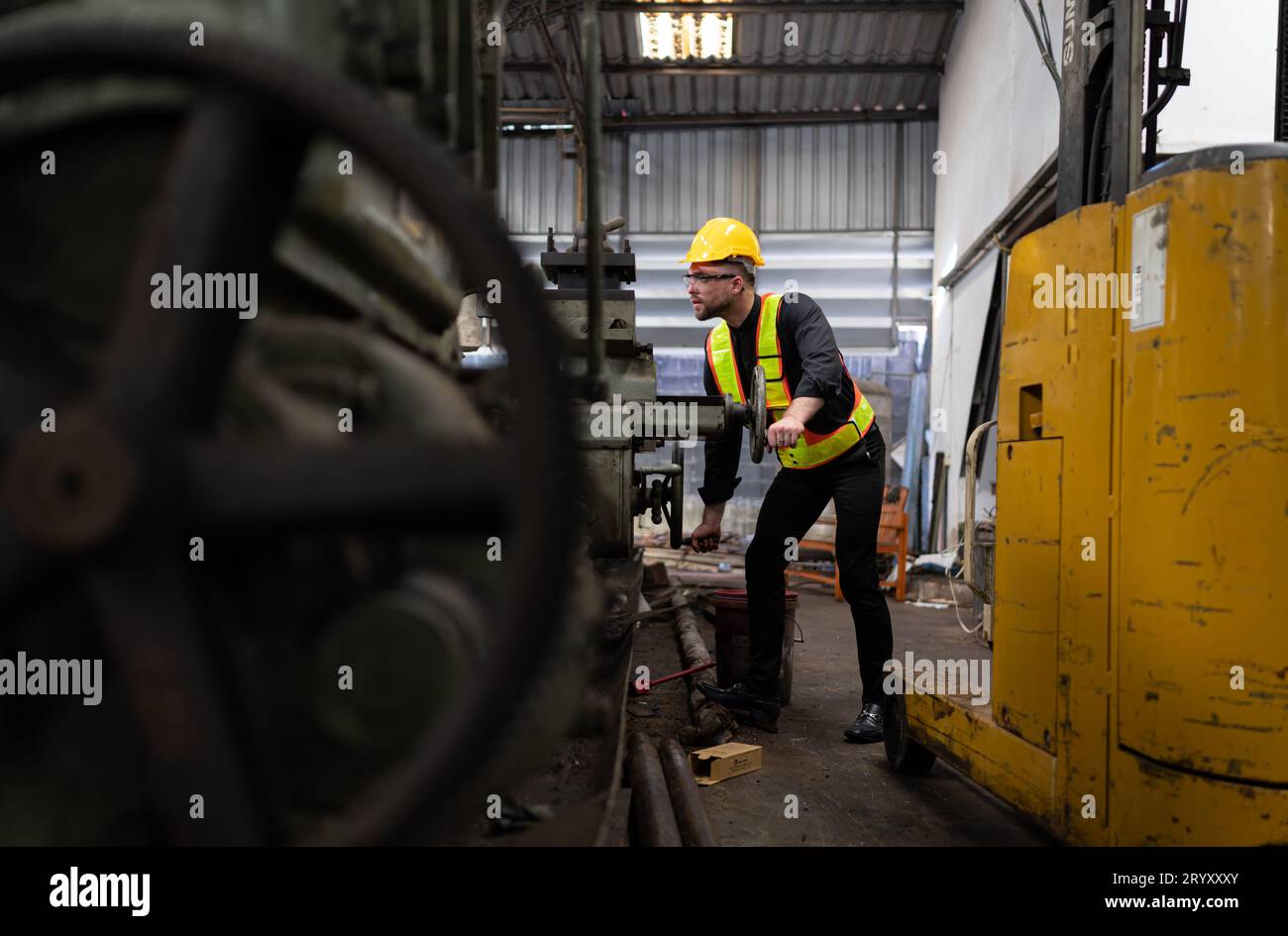 Mechanical engineers enter the old machinery warehouse to inspect and ...