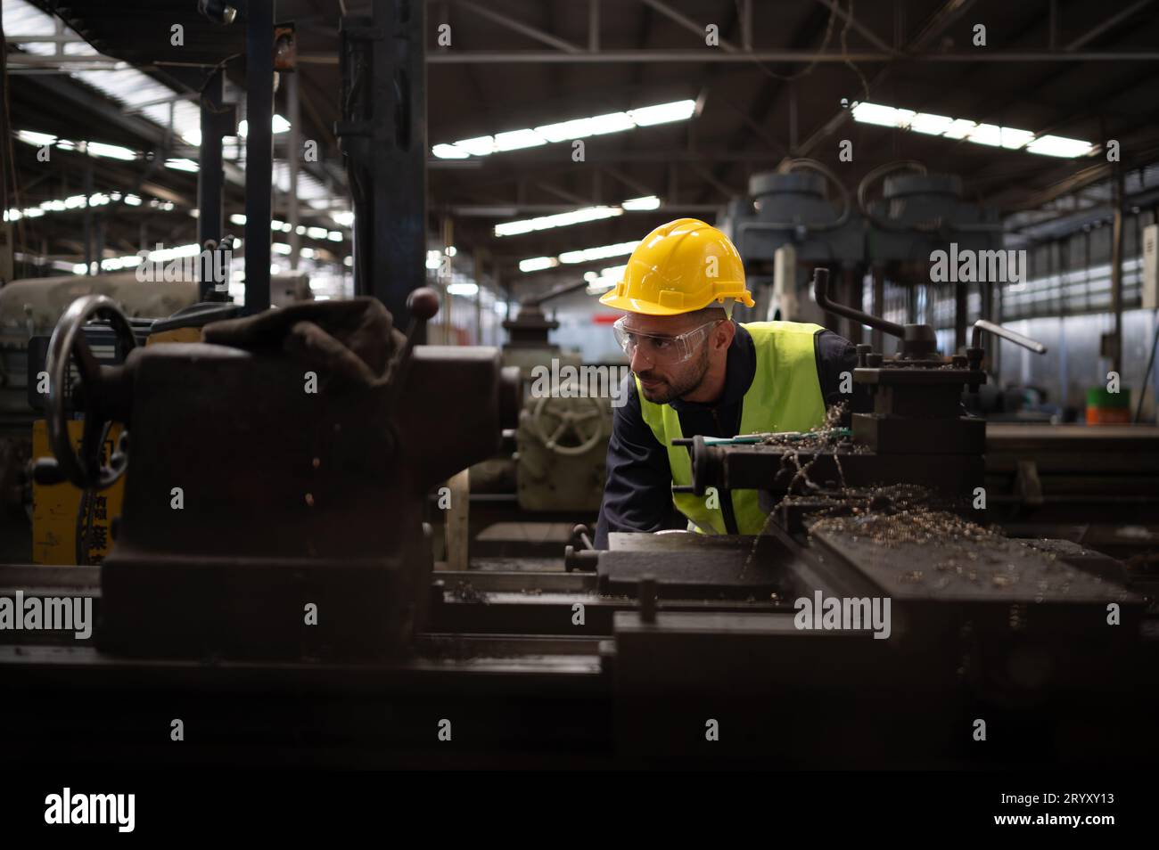 Mechanical engineers enter the old machinery warehouse to inspect and ...