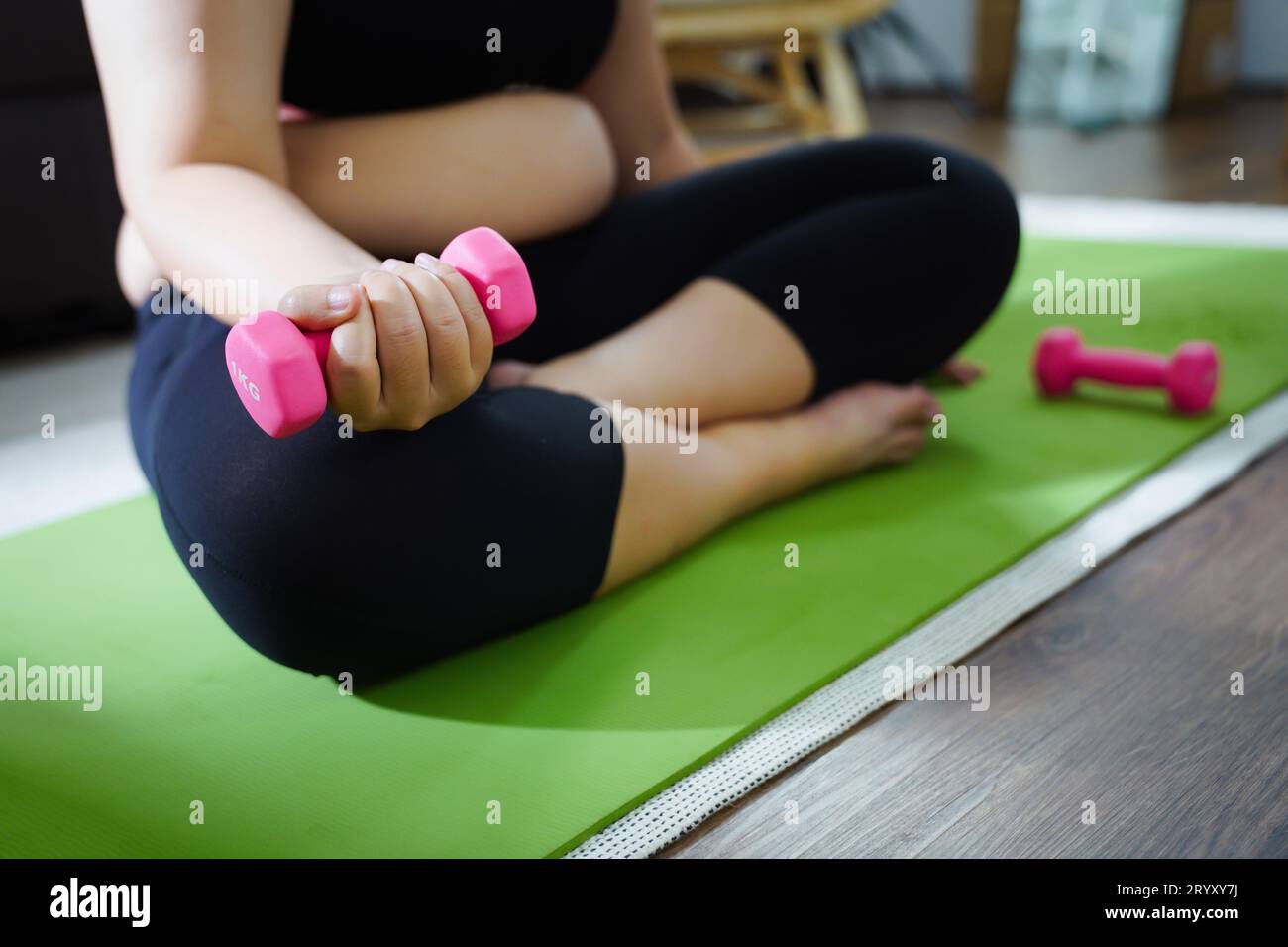 Overweight woman exercising for weight loss. exercise with dumbbells in ...