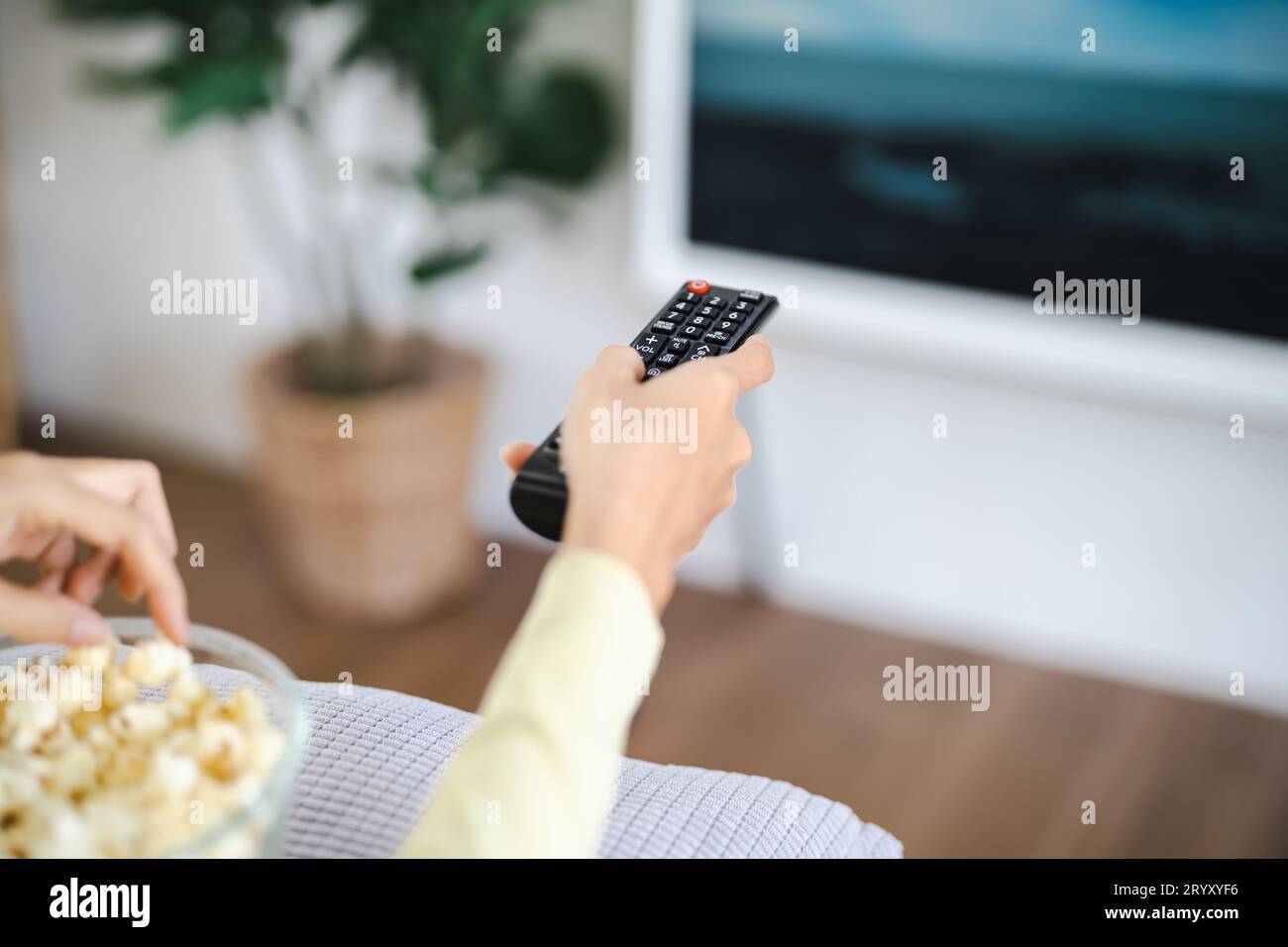 Asian woman Watching smart TV and using remote controller Hand holding ...