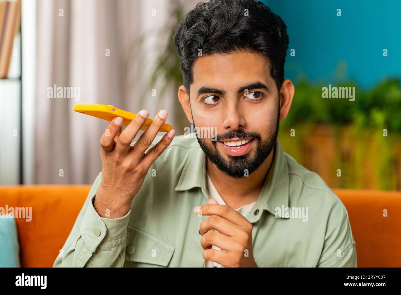 Happy excited Indian man making phone call conversation with friends at ...