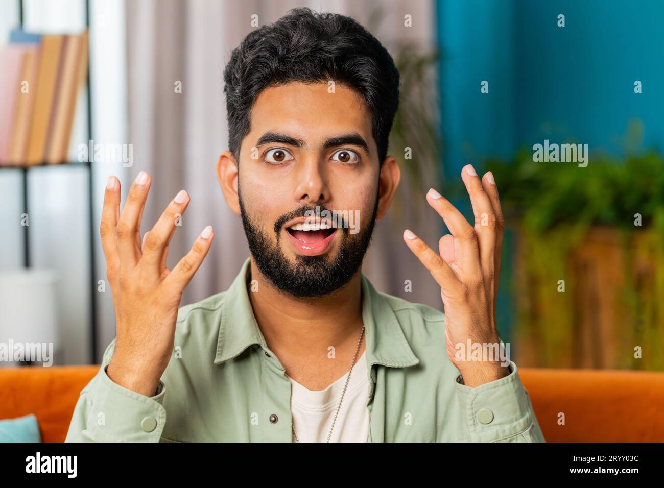 Oh my God Wow. Excited amazed young Indian man surprised looking at ...