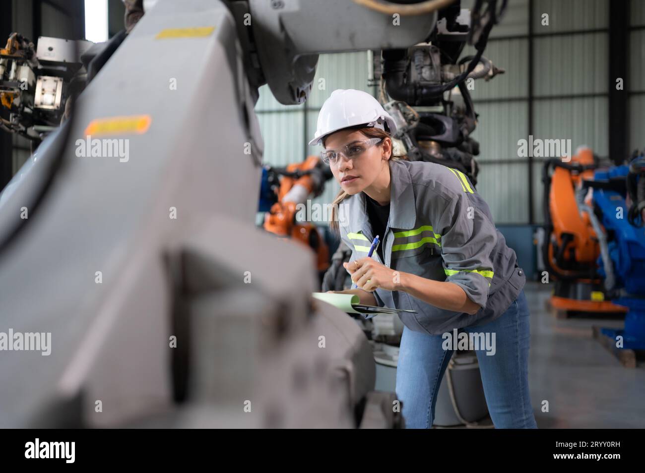 A female engineer checking documented items after installing a program ...