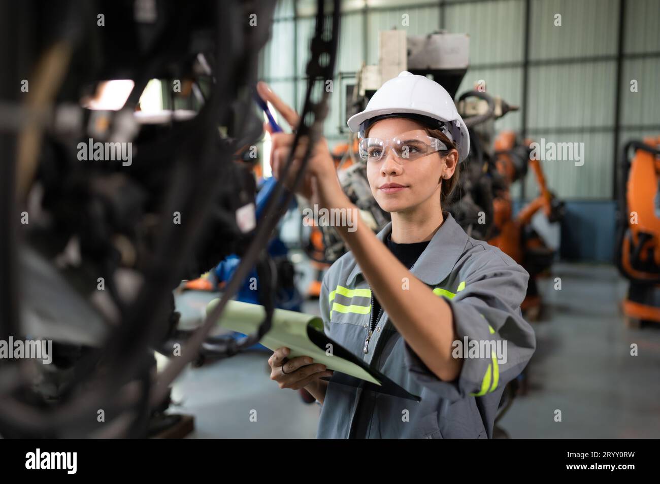 A female engineer checking documented items after installing a program ...
