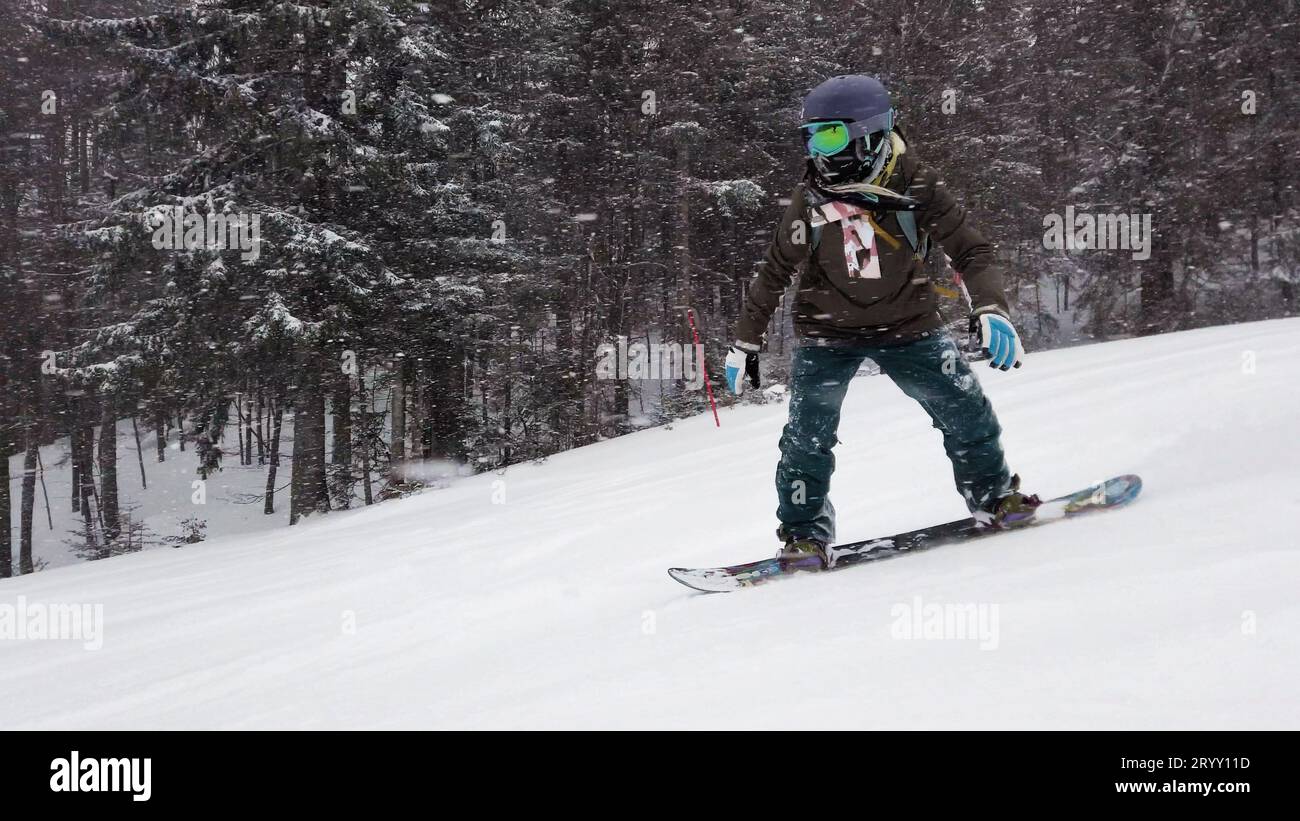 Girl snowboarding on slopes. Snow falling Stock Photo - Alamy