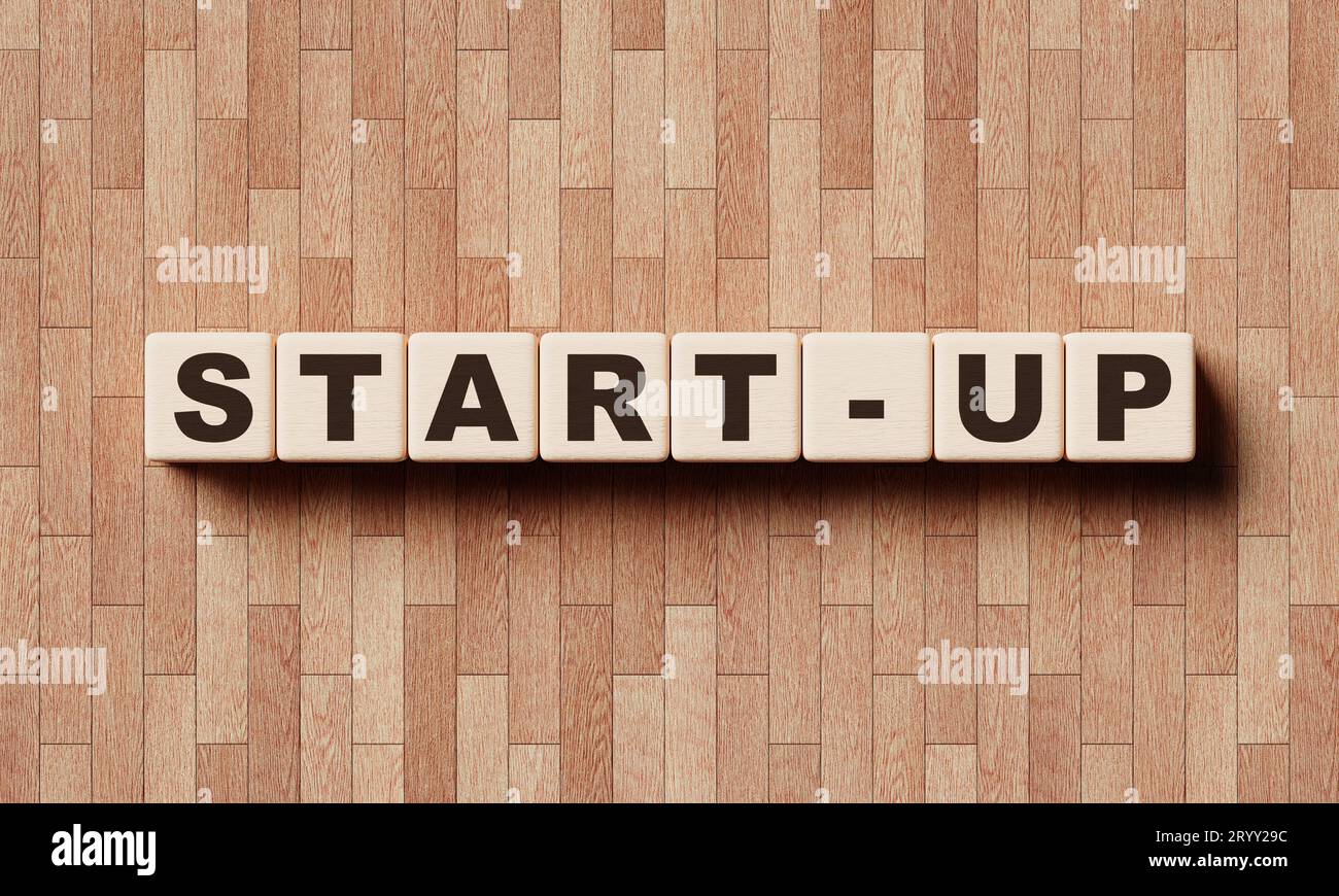 START-UP wooden word block cubes with laminate background. Business ...