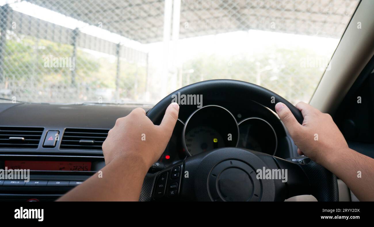 Man driving with both hands on steering wheel selective focus. safety ...