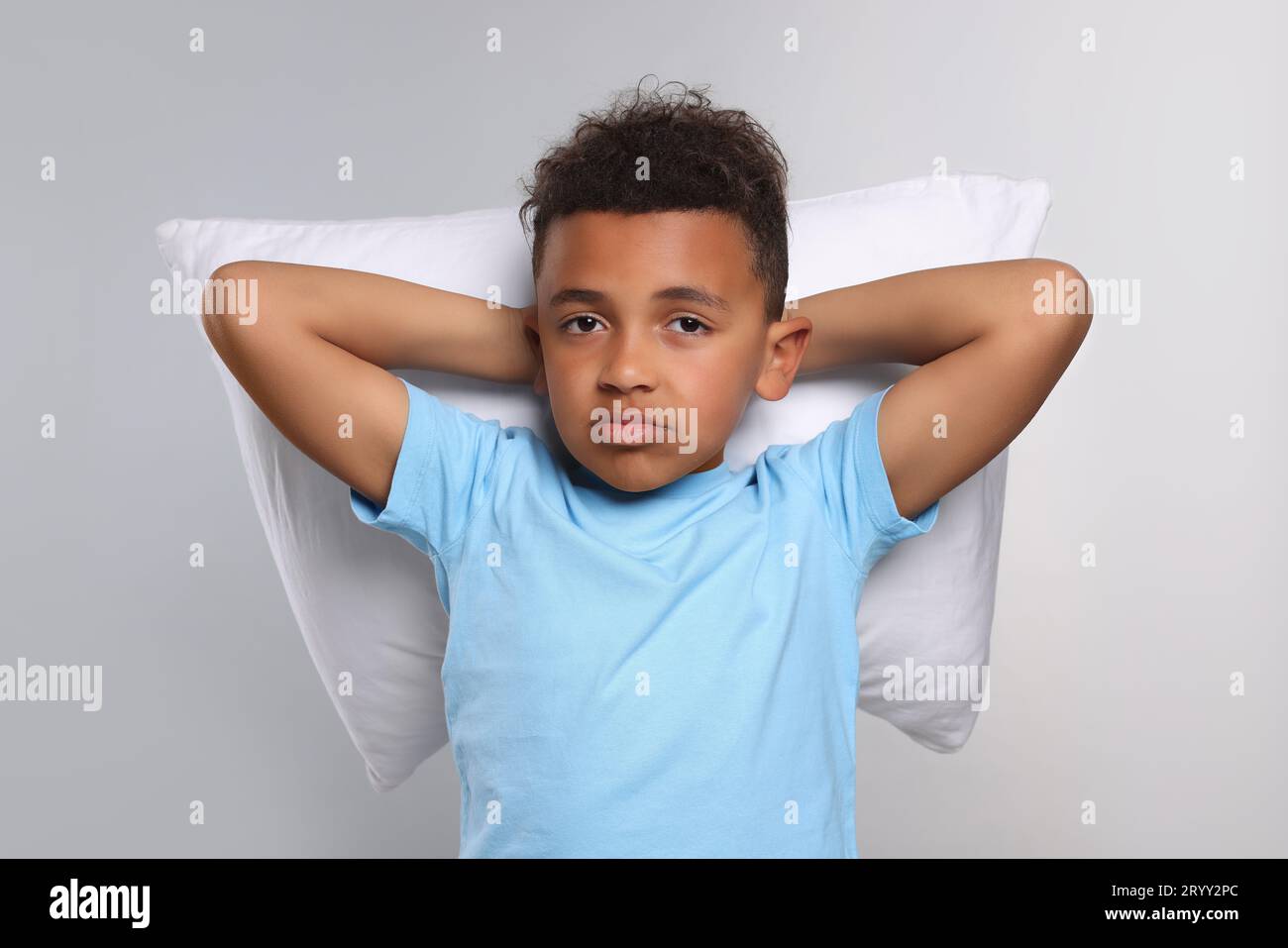 Boy with pillow on grey background. Insomnia problem Stock Photo - Alamy